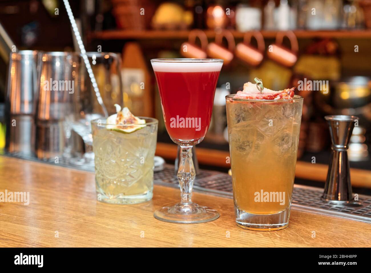 Three cocktails served on bar counter Stock Photo - Alamy