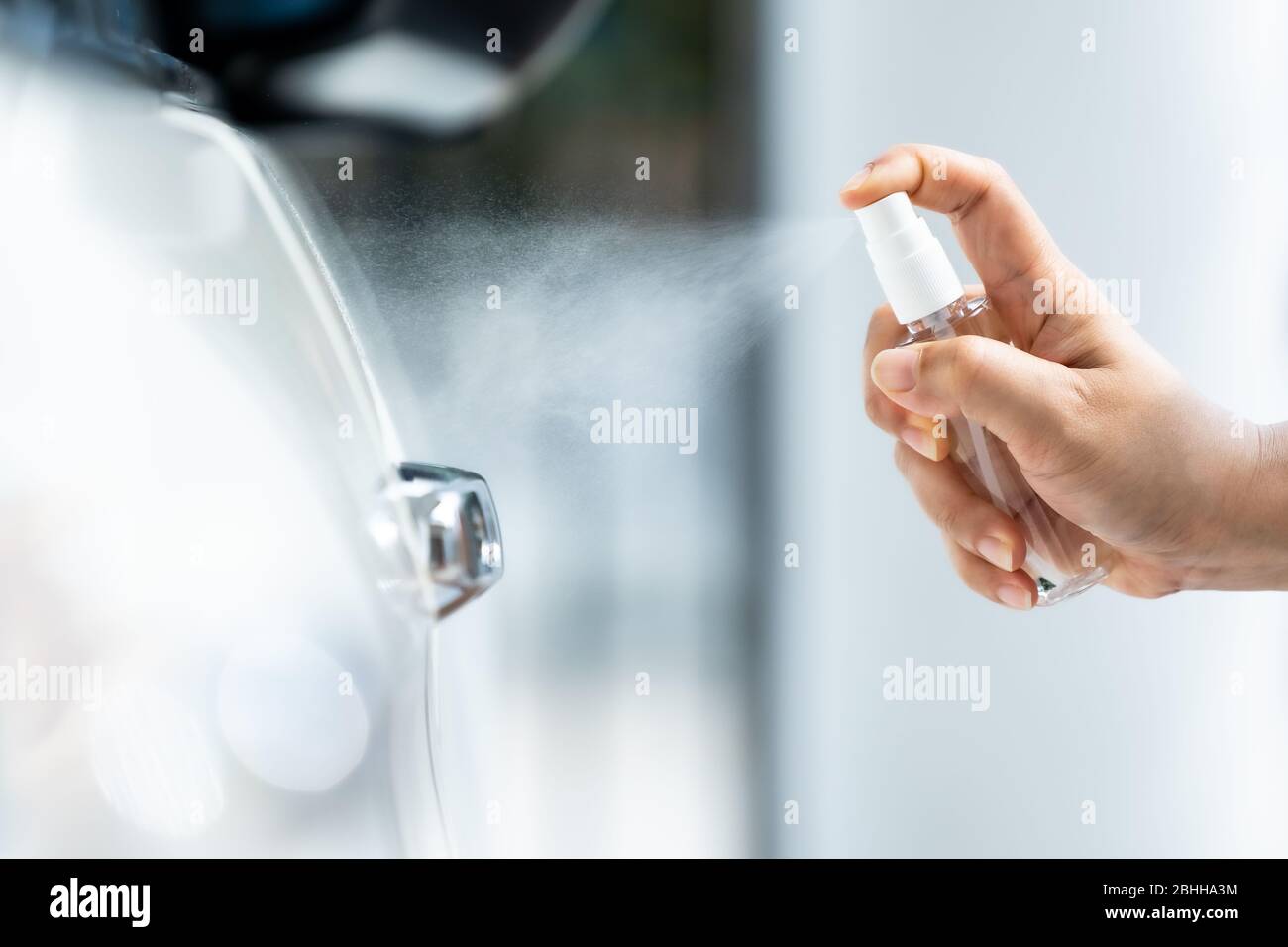 Closeup car wash clening using hand spraying alcohol, disinfectant ...