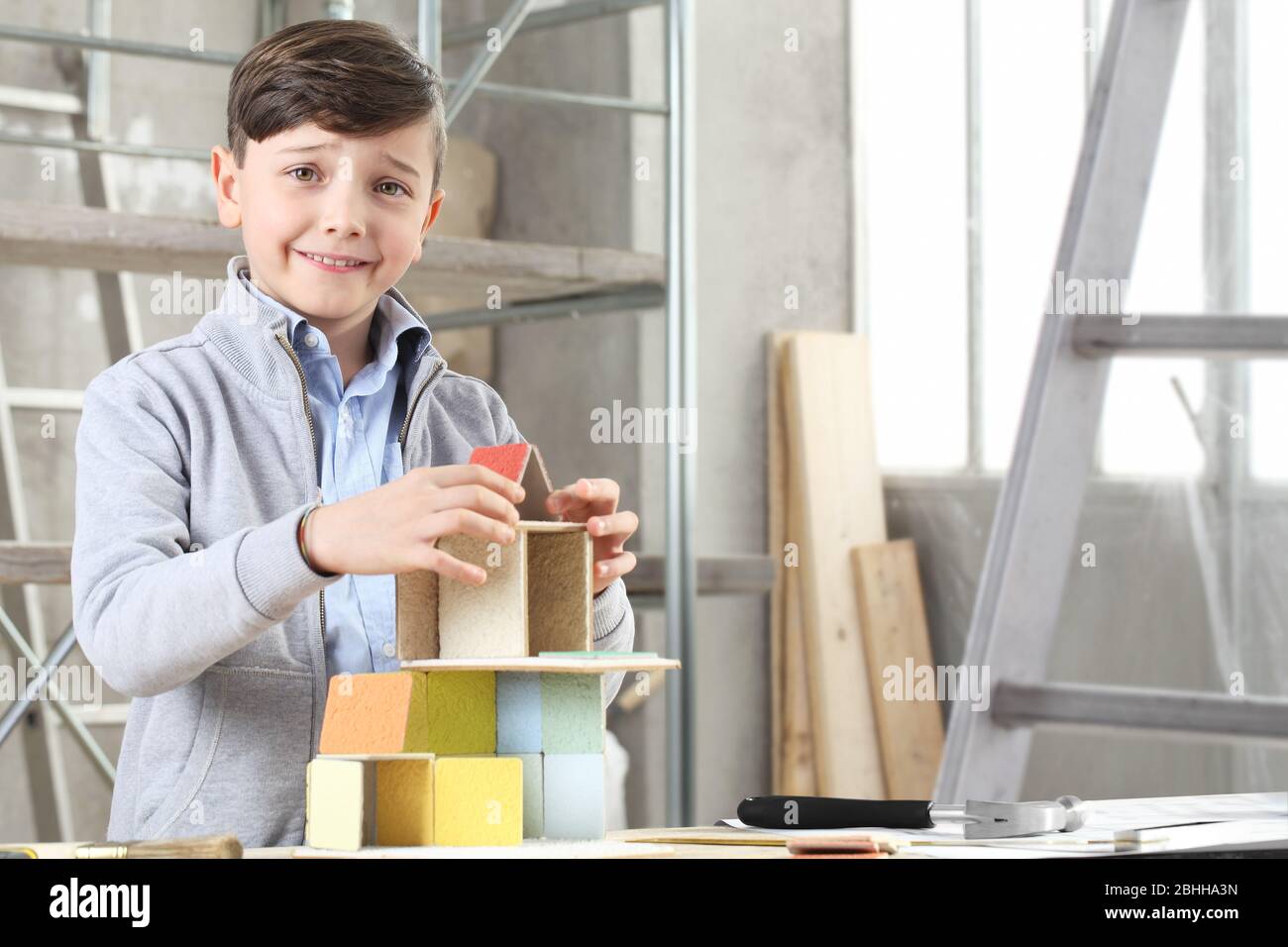 Happy children playing building a house with construction models at ...