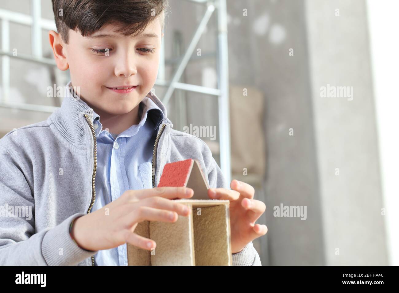 Happy children playing building a house with construction models at ...
