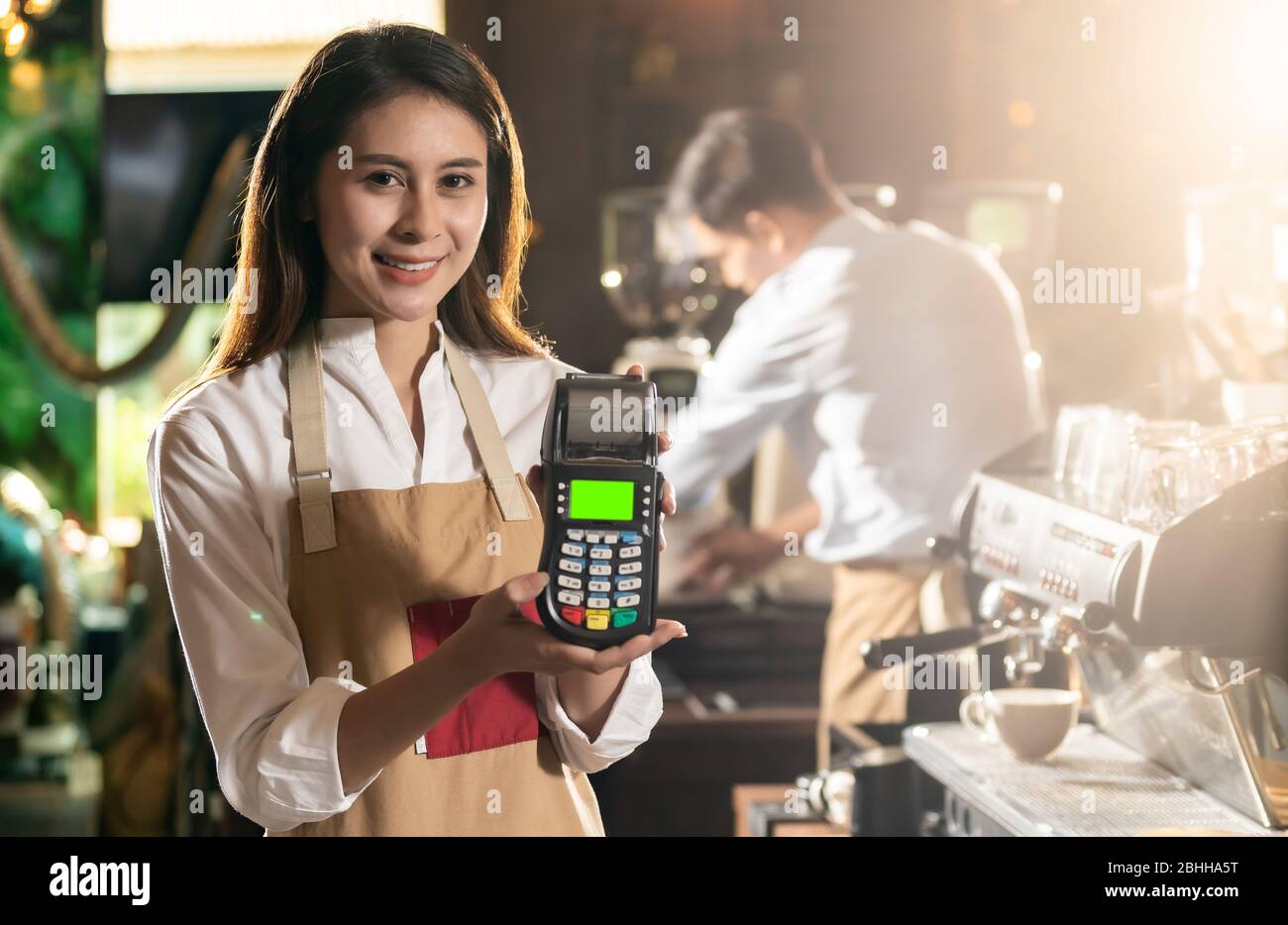 Asian Barista woman holding creadit card reader machine cashless ...