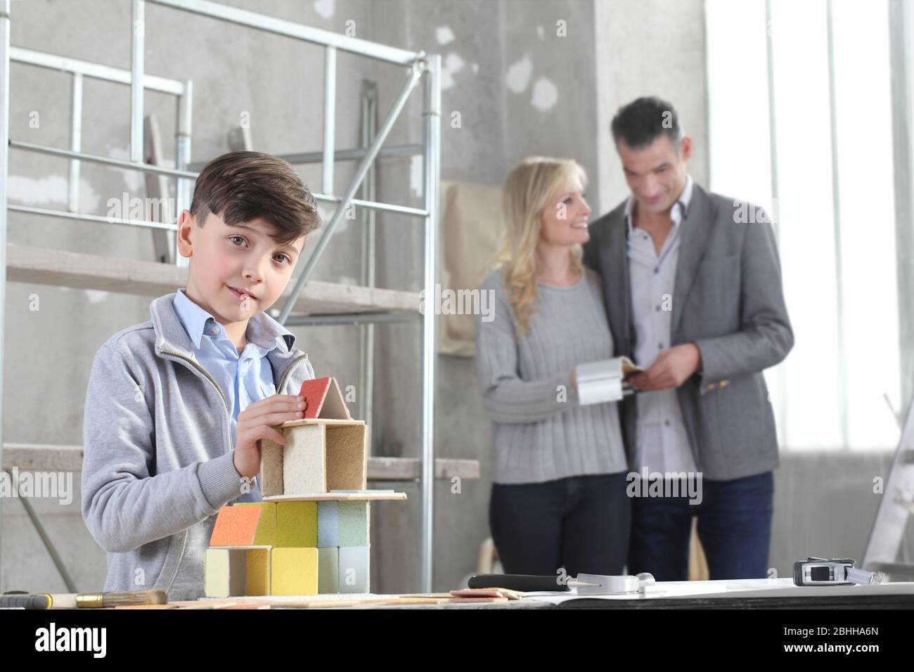 Happy children and his family playing building a house with ...