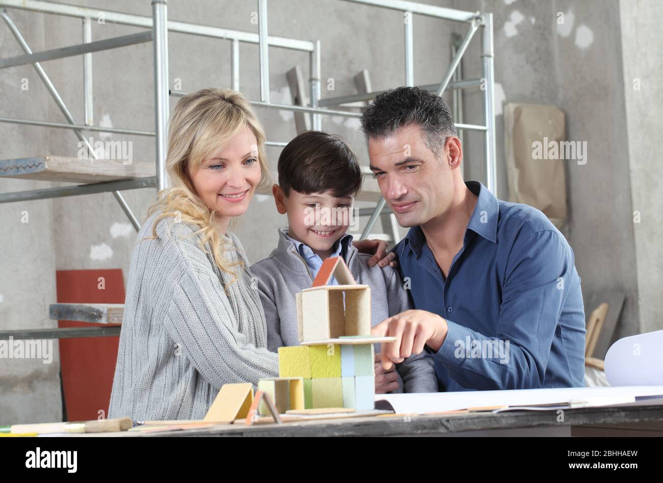 Happy children and his family playing building a house with ...
