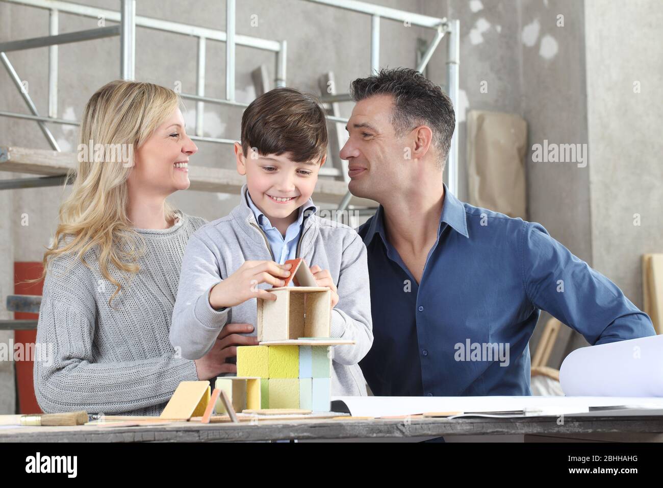 Happy children and his family playing building a house with ...