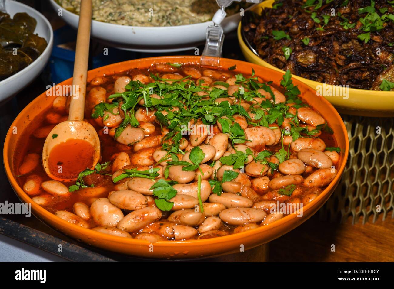 Butter beans in tomato sauce served in a very large pan, during food ...