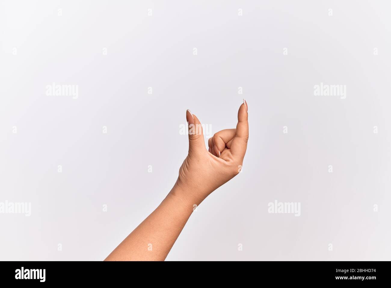 Hand of caucasian young woman picking and taking invisible thing ...