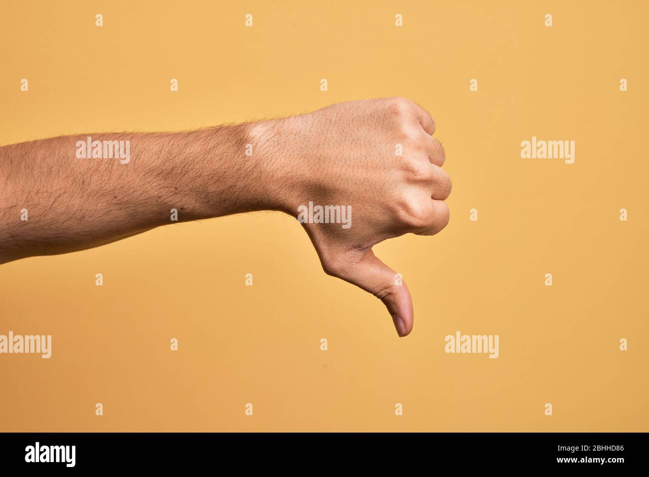 Hand of caucasian young man showing fingers over isolated yellow ...