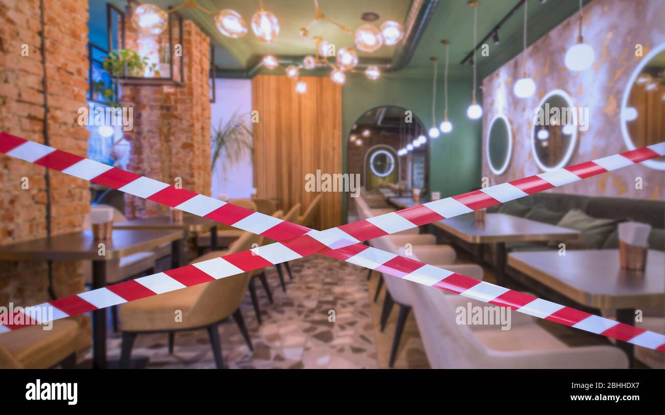 Hazard safety stripes across empty closed restaurant Stock Photo - Alamy