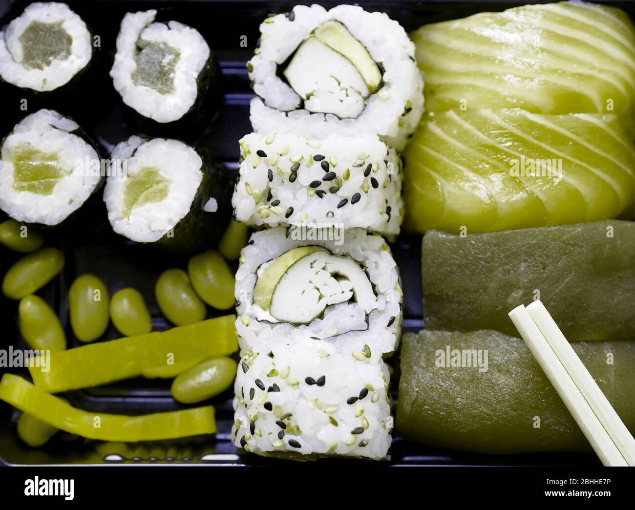 Sushi tray in green selective color Stock Photo - Alamy