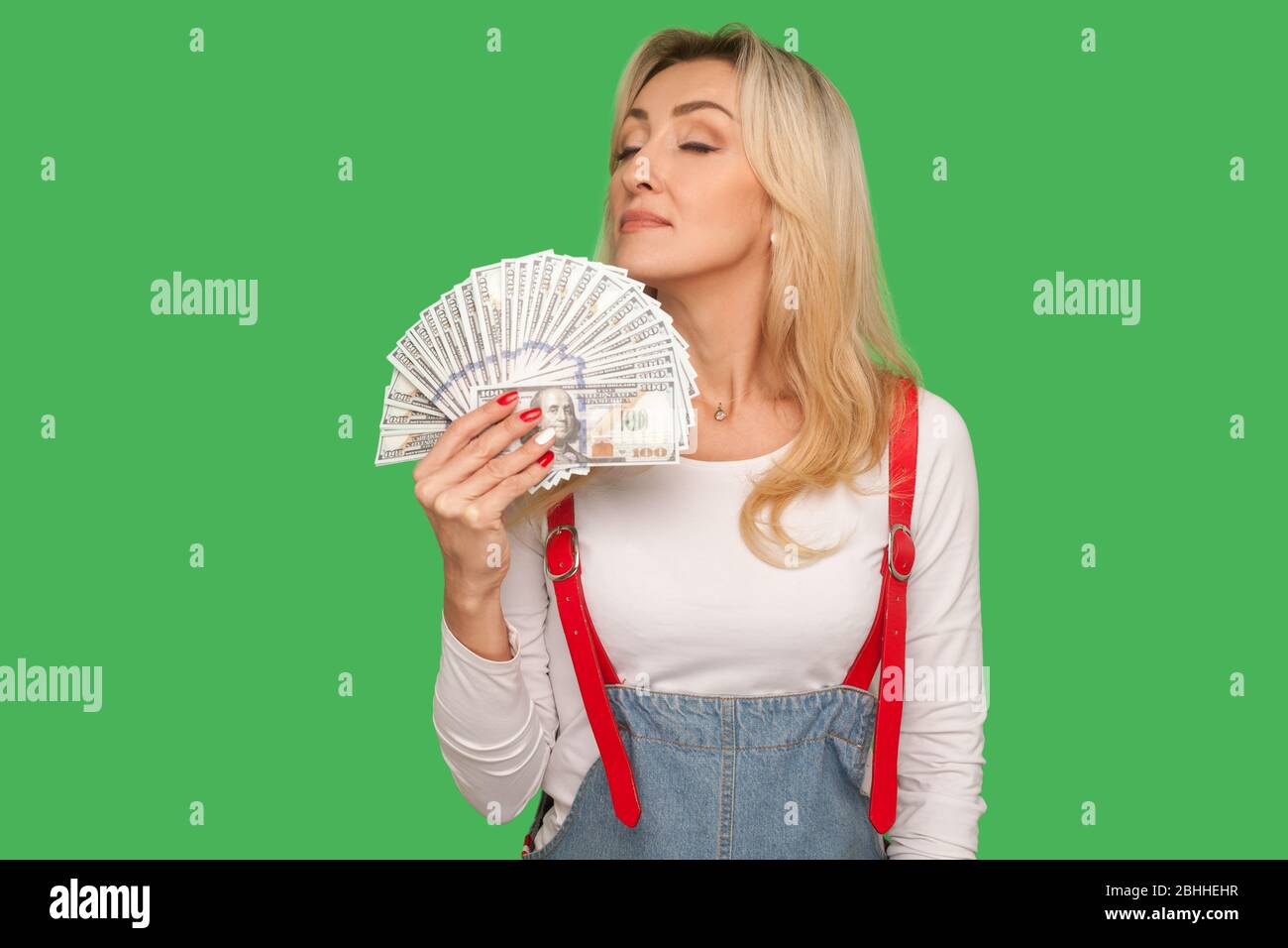 I love rich life! Portrait of greedy adult woman in stylish denim ...