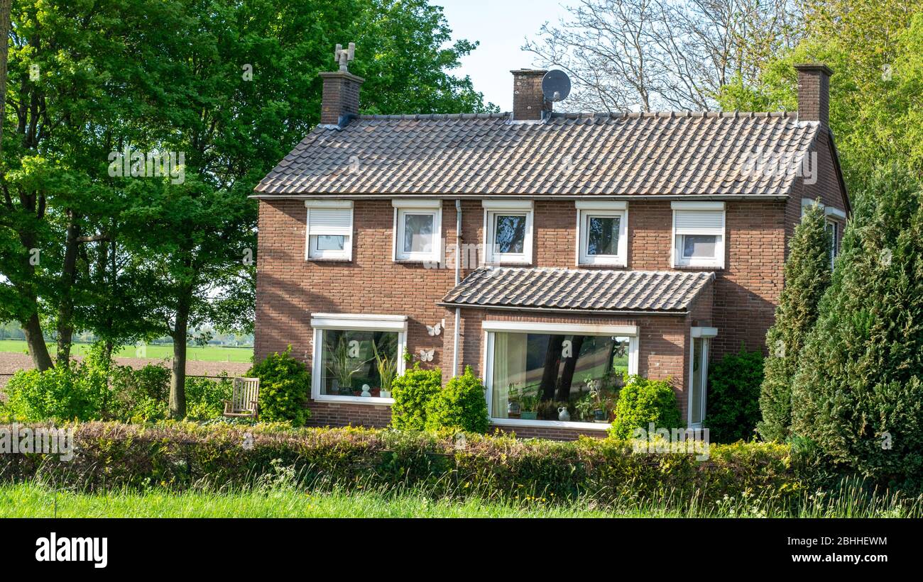 A Typical old Dutch house standing in a Dutch polder landscape next to ...