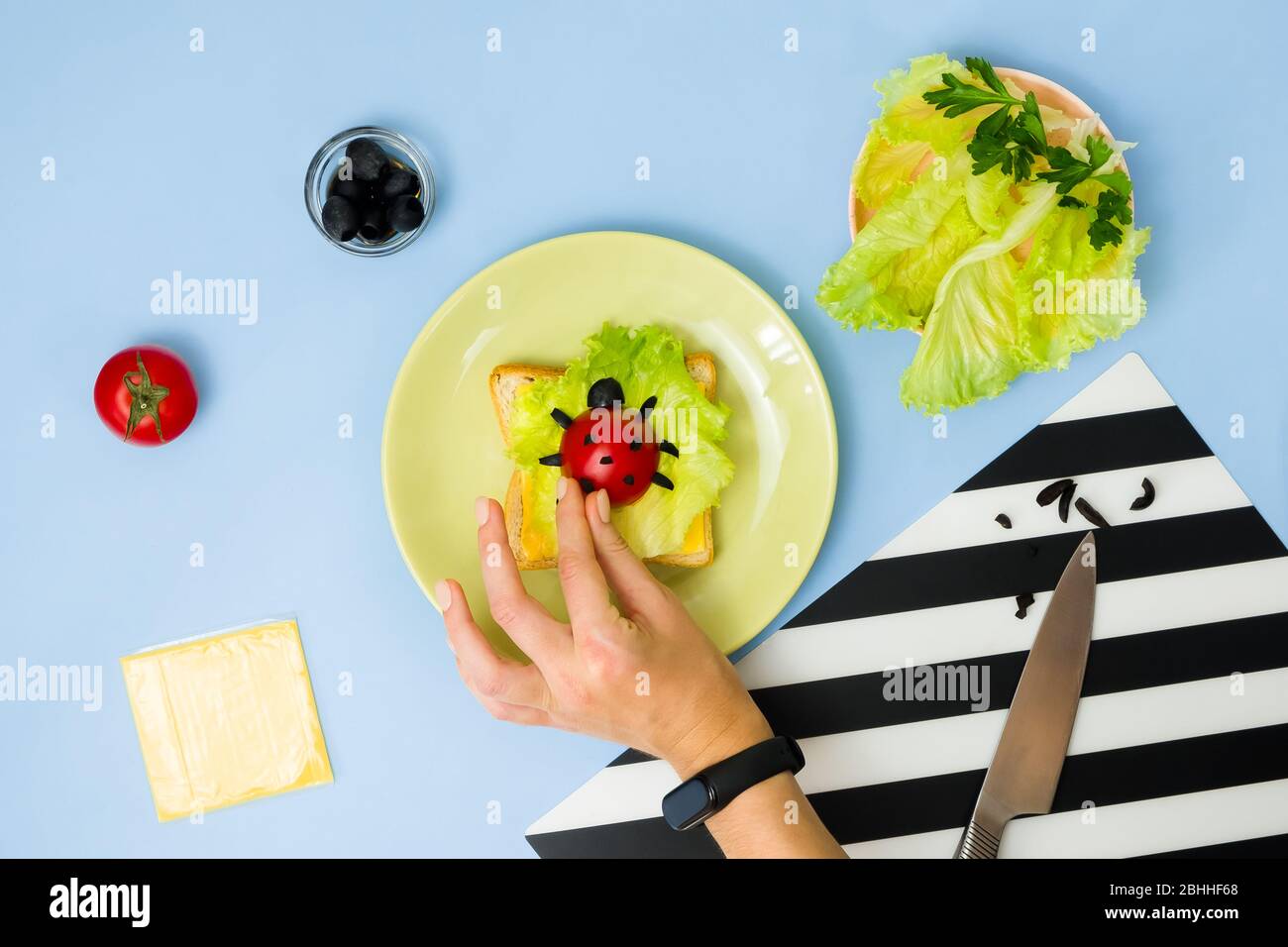 Fun food art for kids. Ladybug sandwich on blue background. How to make ...