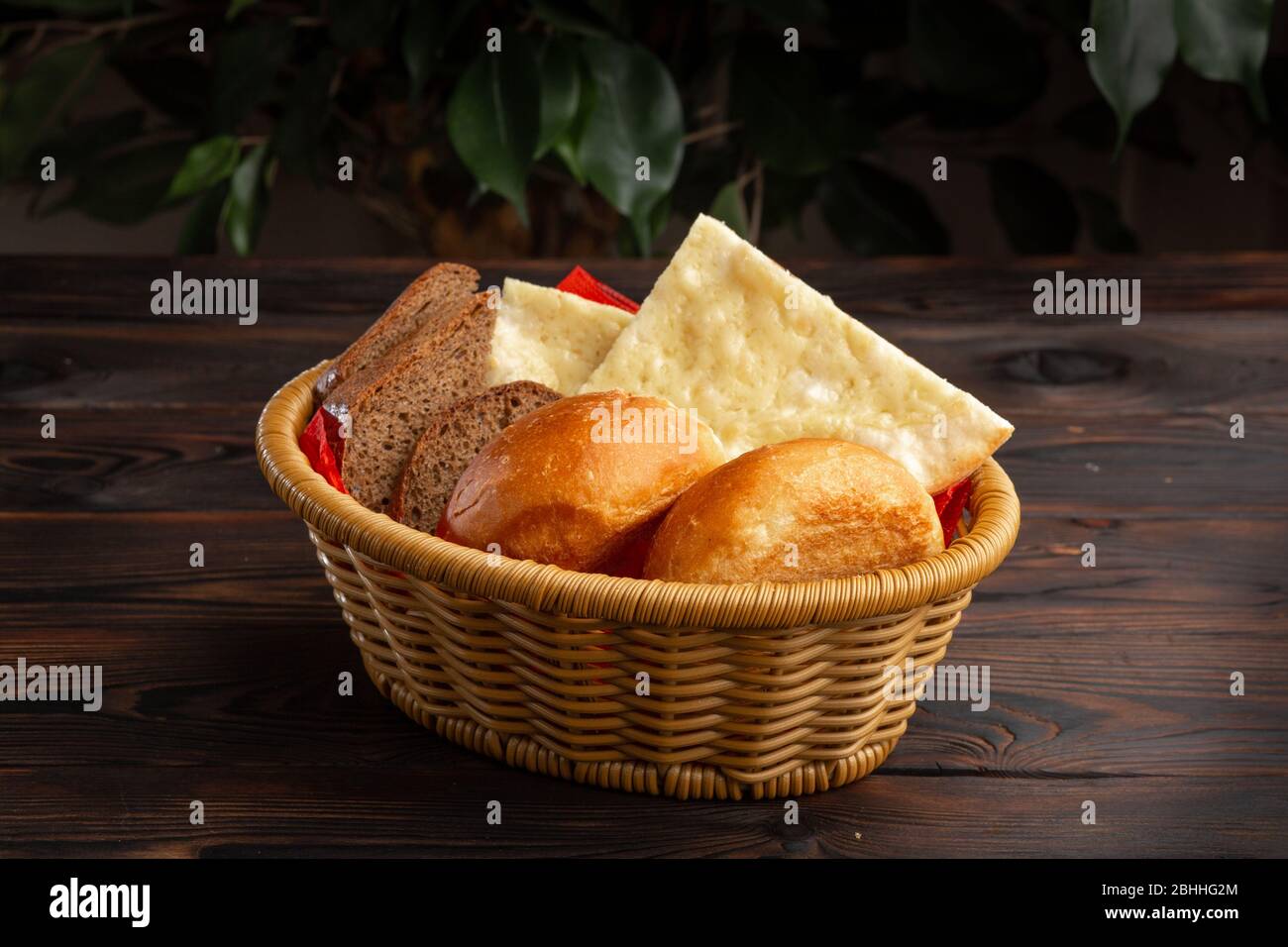 assorted bread in a basket on a dark wooden background Stock Photo - Alamy