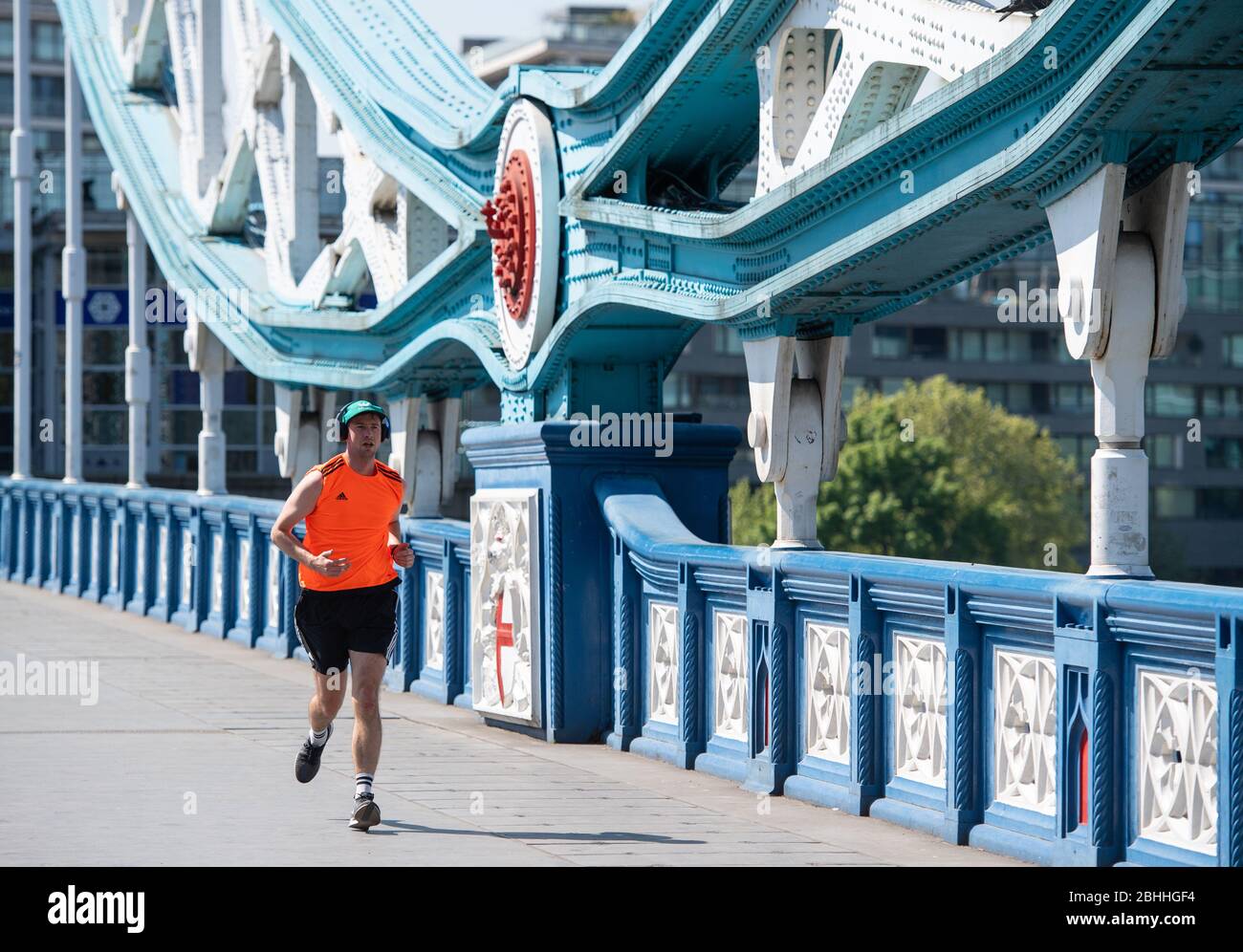 A runner passes over tower bridge hi-res stock photography and images ...
