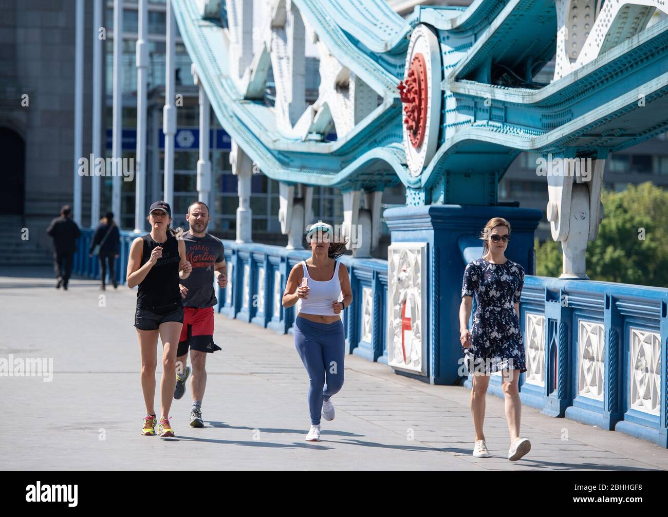 Runners pass over Tower Bridge, in central London, on the course of the ...
