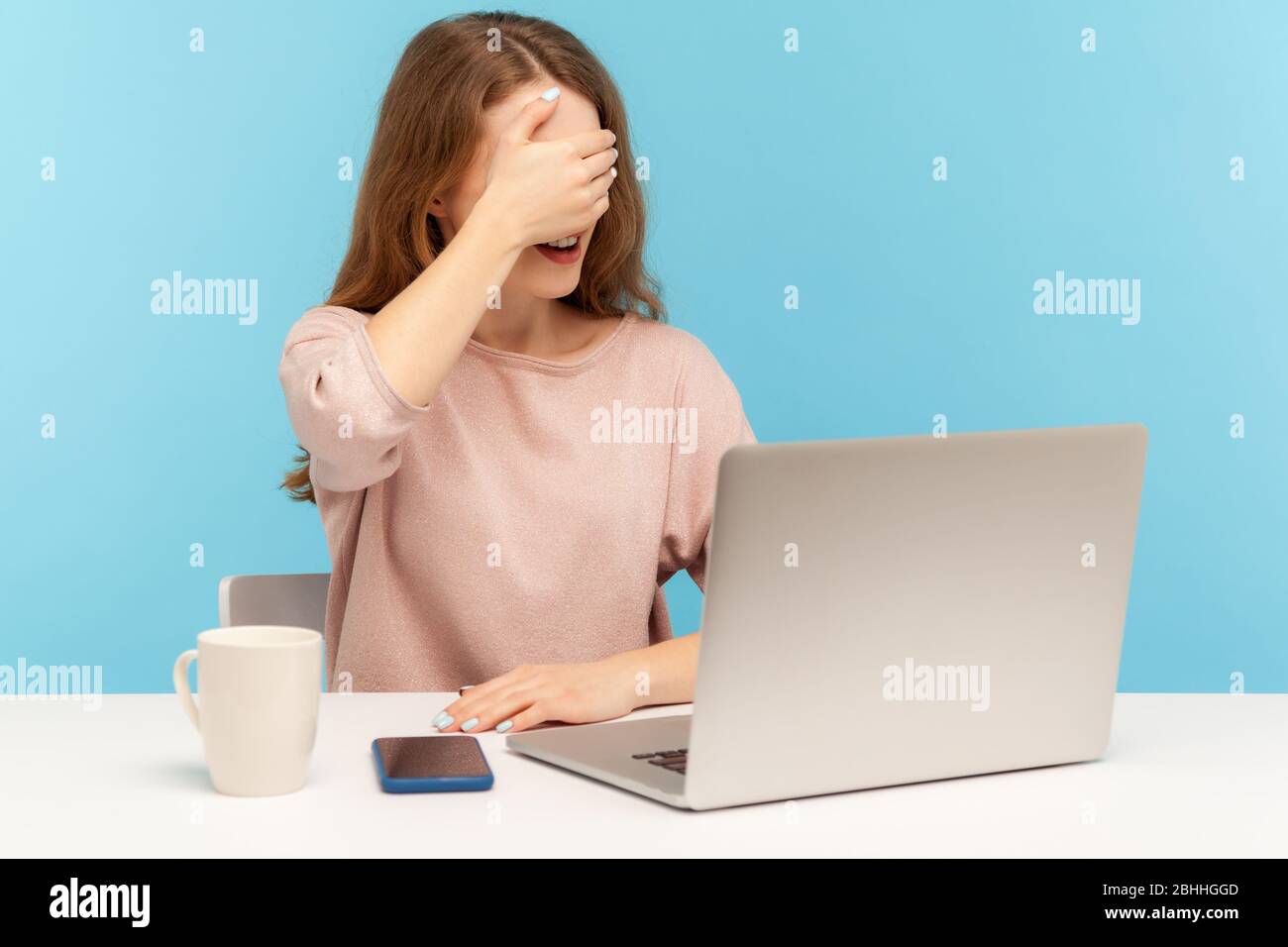 Don't want to look at this. Confused scared woman covering her eyes ...