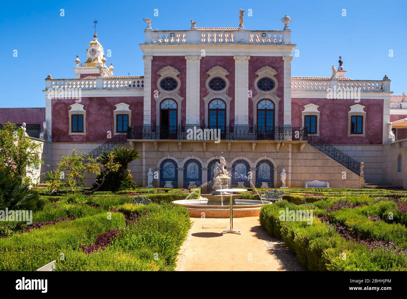 Light bordeaux color of the walls, white details. Palace Estoi ...