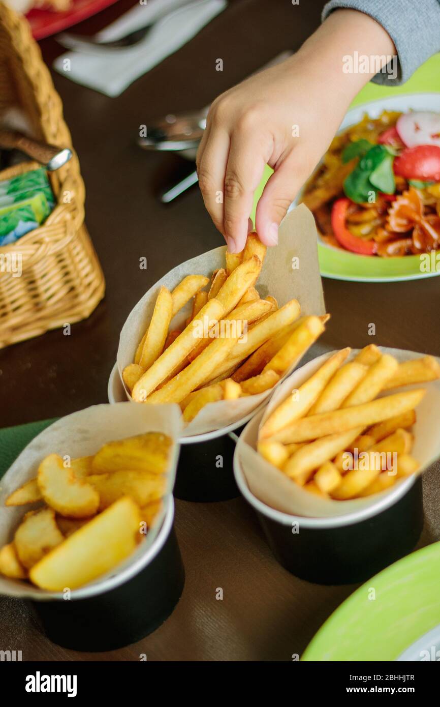kid hand with french fries in a restaurant, great image for your needs ...