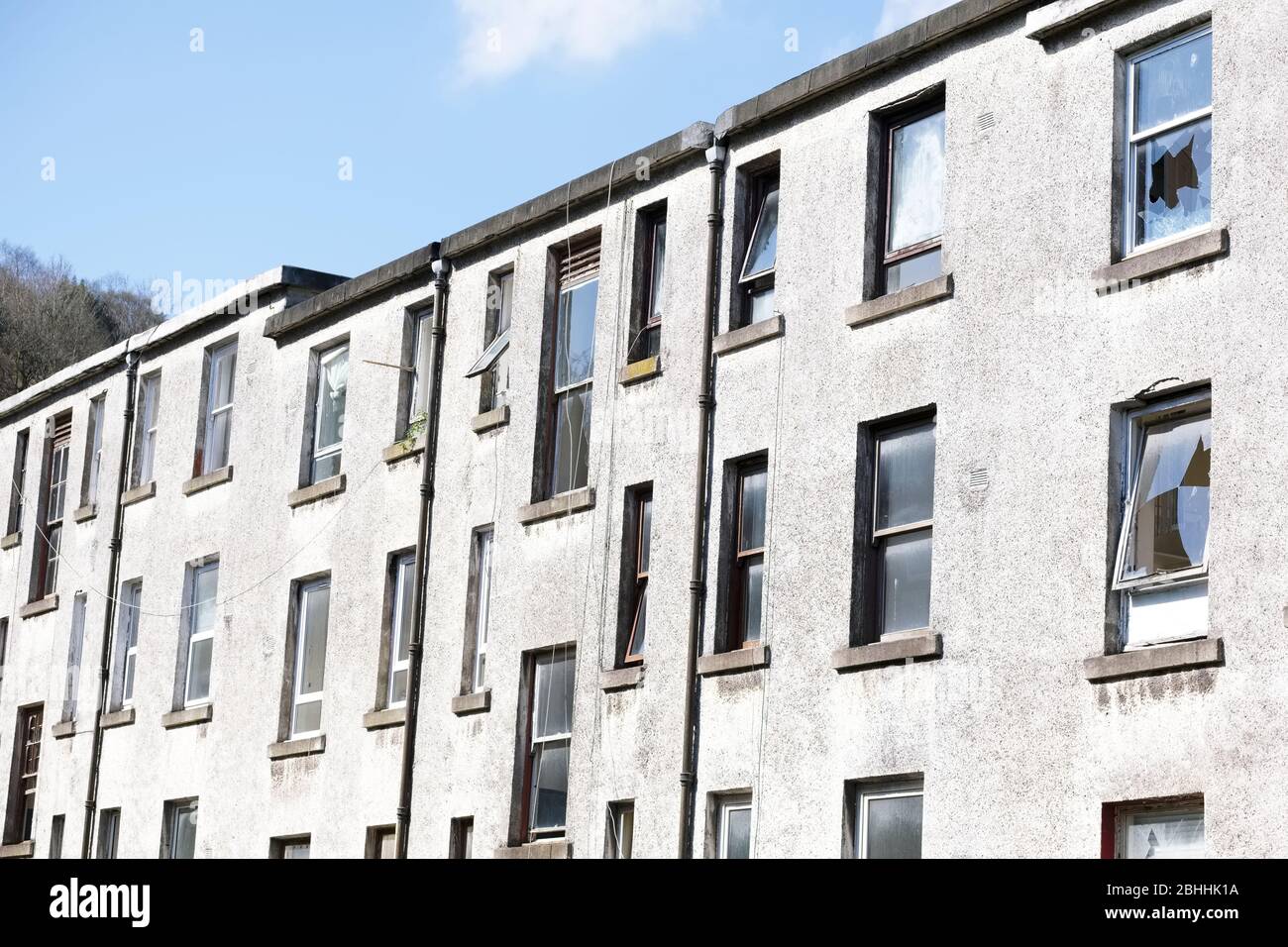Derelict council house in poor housing estate slum with many social ...