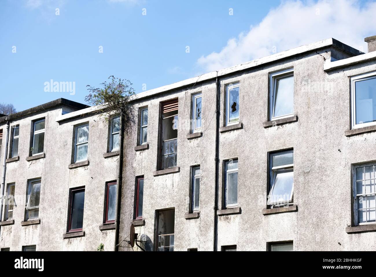 Derelict council house in poor housing estate slum with many social ...