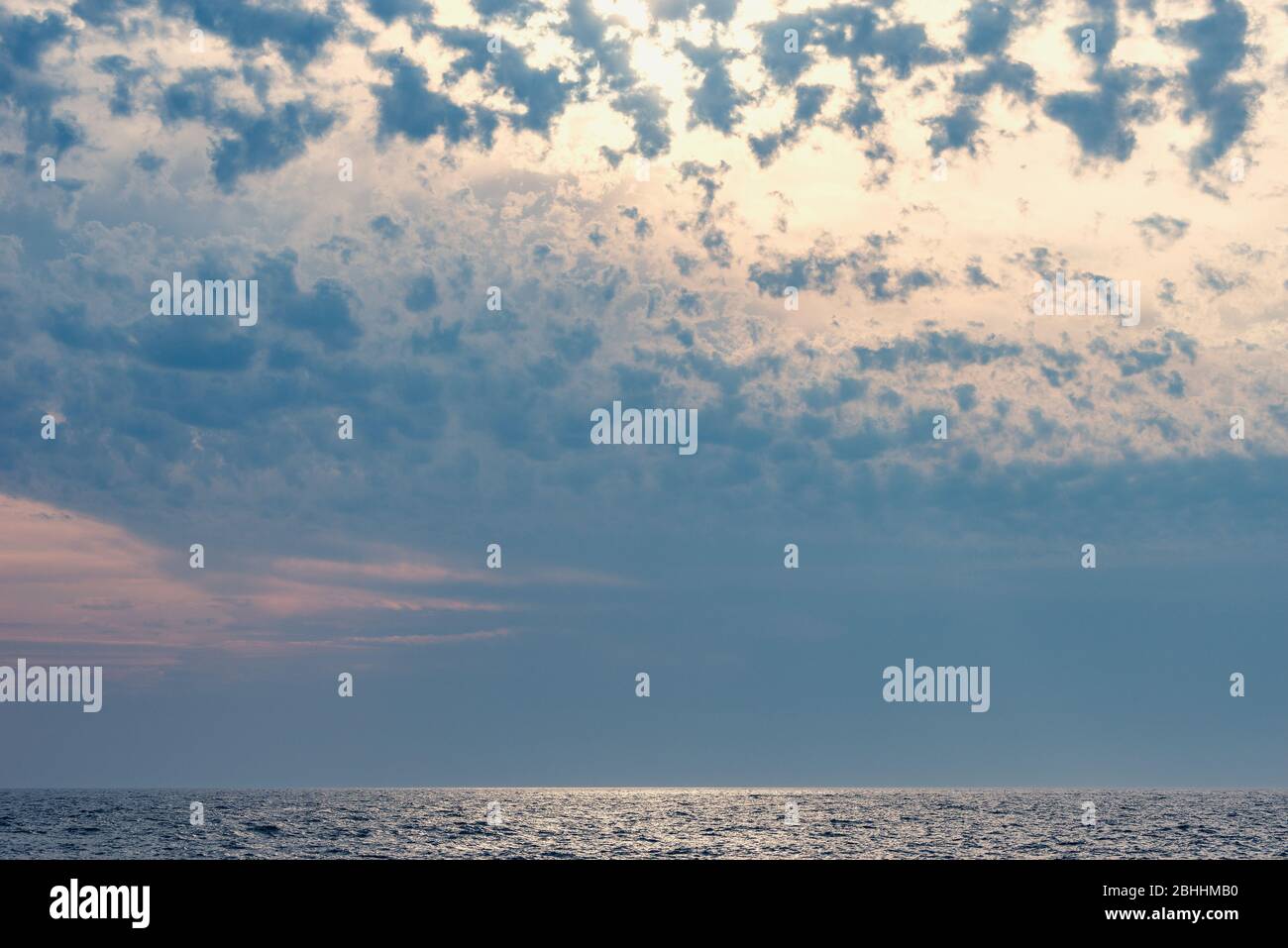 Cloudy sky above surface of the sea Stock Photo - Alamy