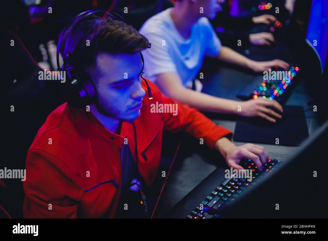 Friends young guys play online video games with headphones in internet ...