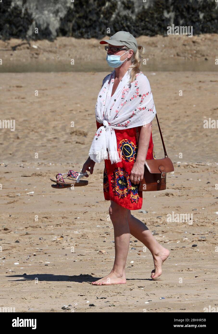 Lady in mask walks on the beach in margate hi-res stock photography and ...