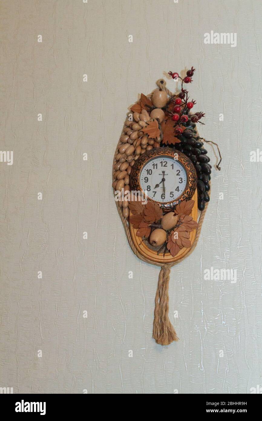Wall mounted wooden clock hanging on the wall Stock Photo - Alamy