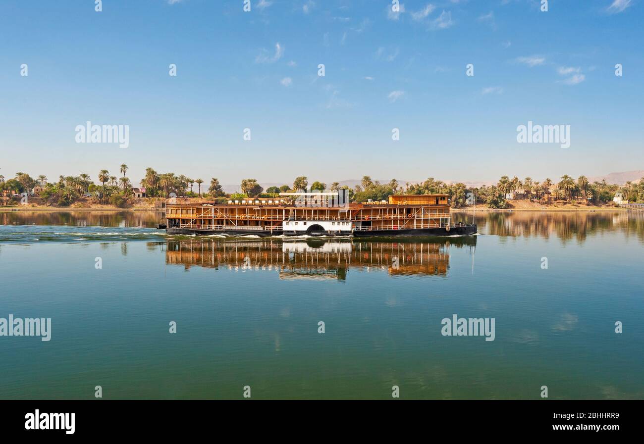 Large luxury traditional Egyptian river cruise boat sailing on the Nile ...