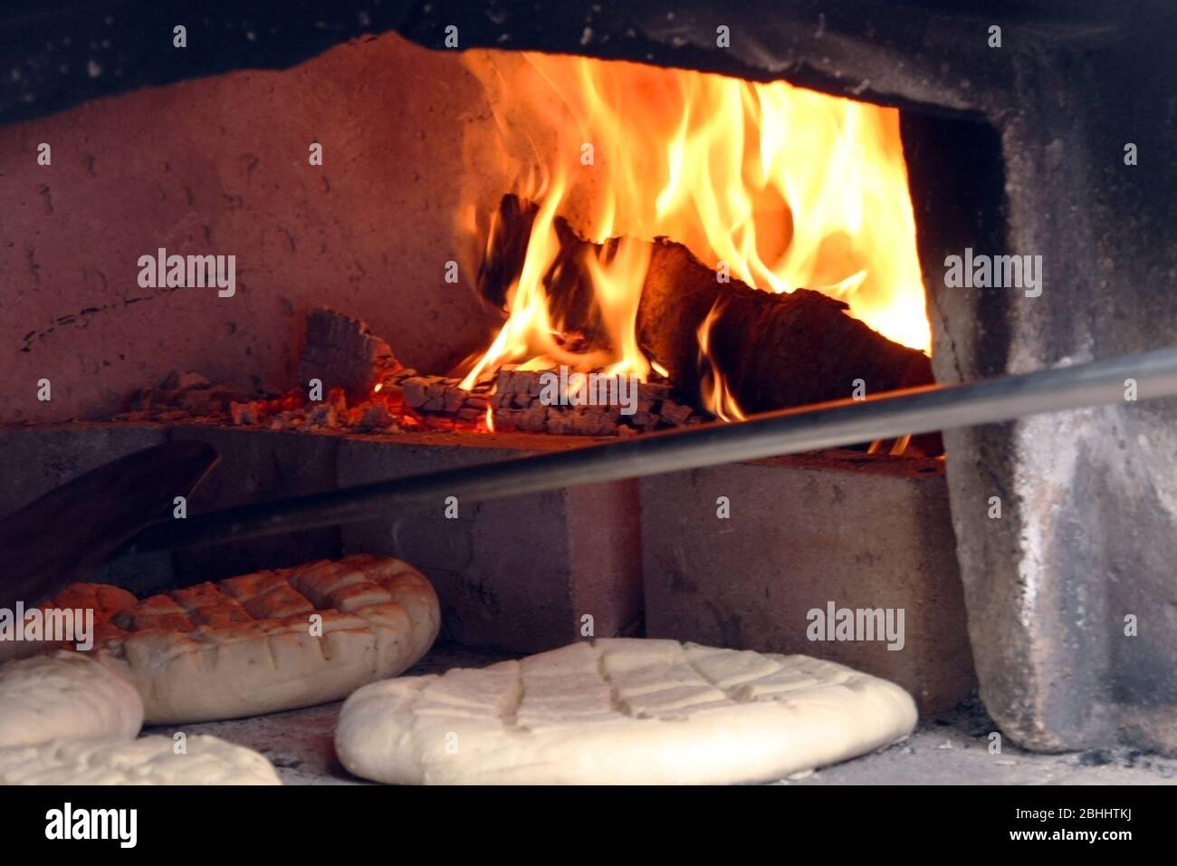 loaves of bread while cooking in an old medieval wood oven Stock Photo ...