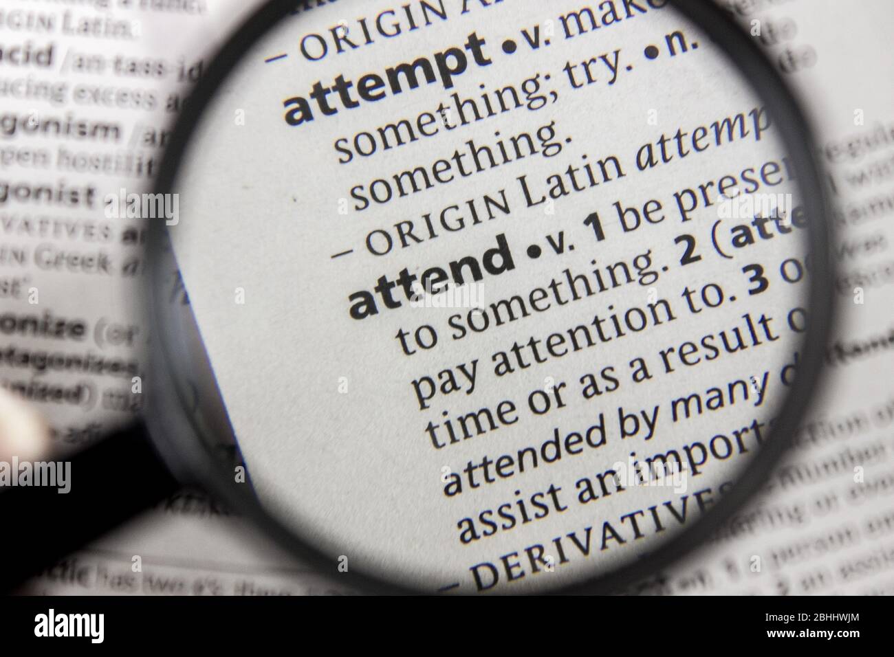 The word or phrase attend in a dictionary book Stock Photo - Alamy