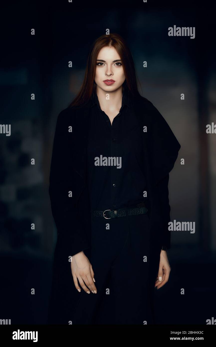 Low key portrait of beautiful girl with natural make up and red lips ...