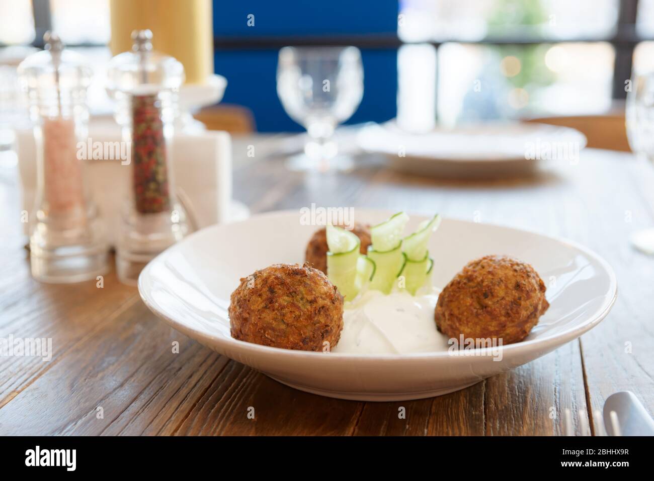 Vegetable croquettes with sour cream on restaurant table, Greek dish ...