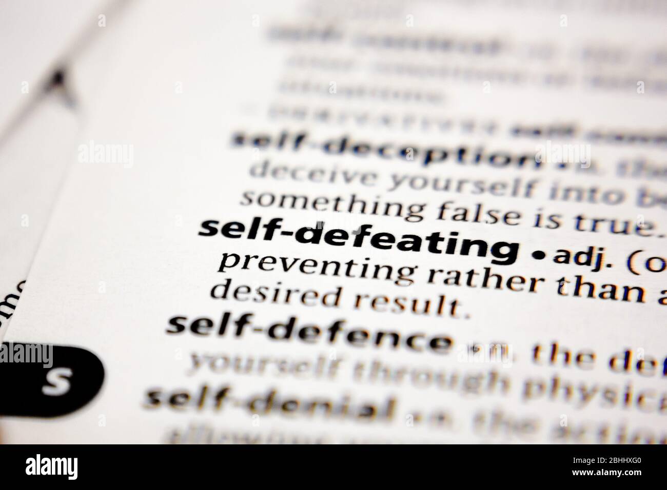 Word or phrase self-defeating in a dictionary Stock Photo - Alamy