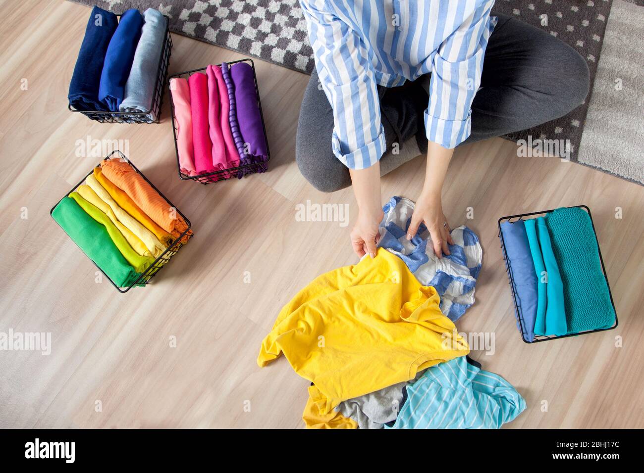 Woman folding clean clothes hi-res stock photography and images - Alamy