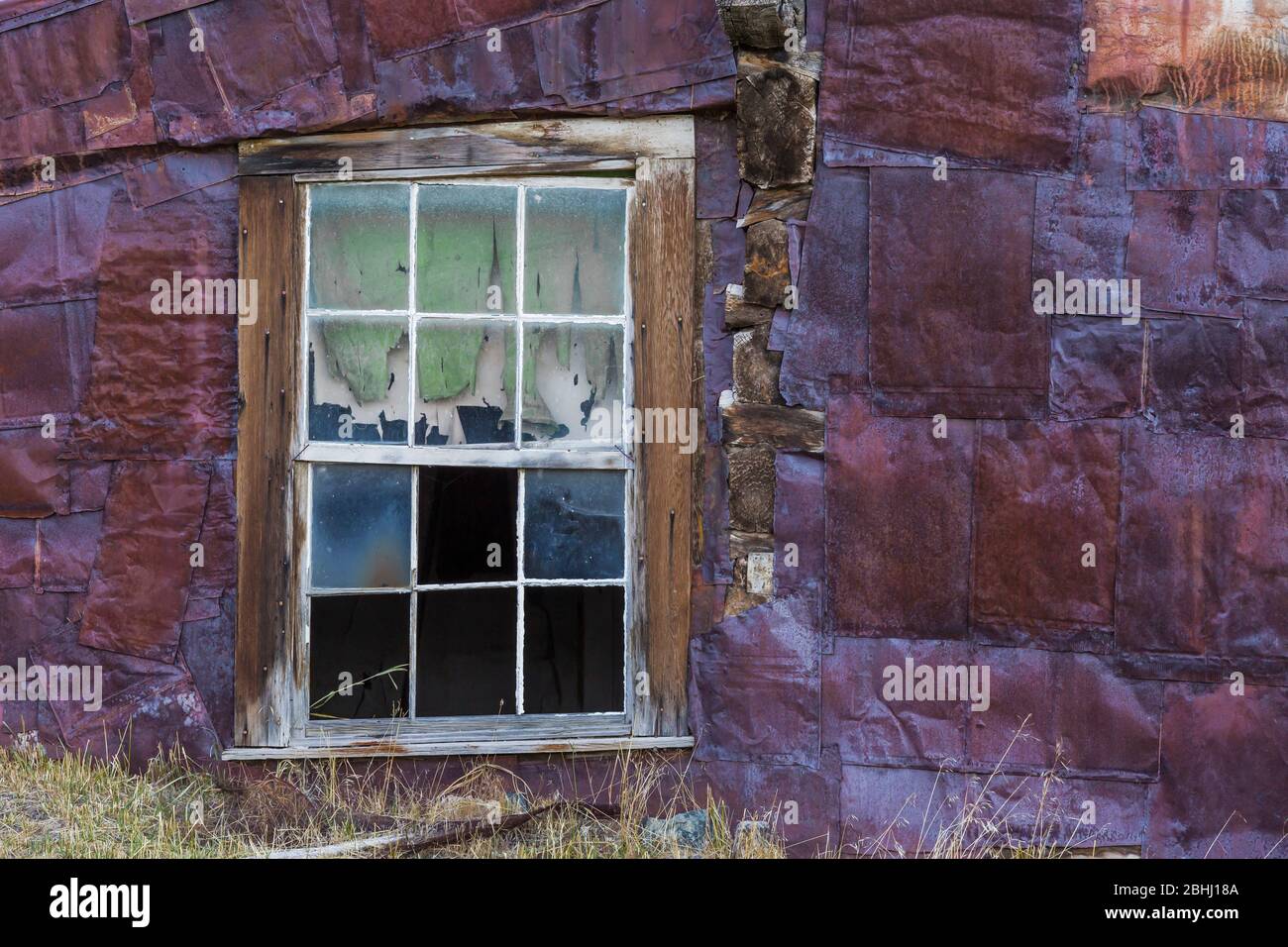 Metal-sheathed log cabin in the old silver and cinnabar mining ghost ...