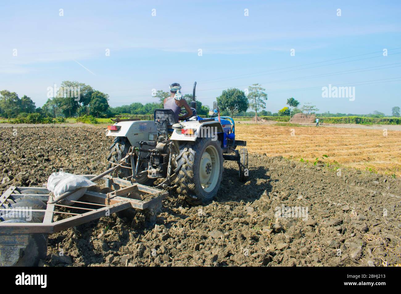 Indian farmer ploughing field tractor hi-res stock photography and ...