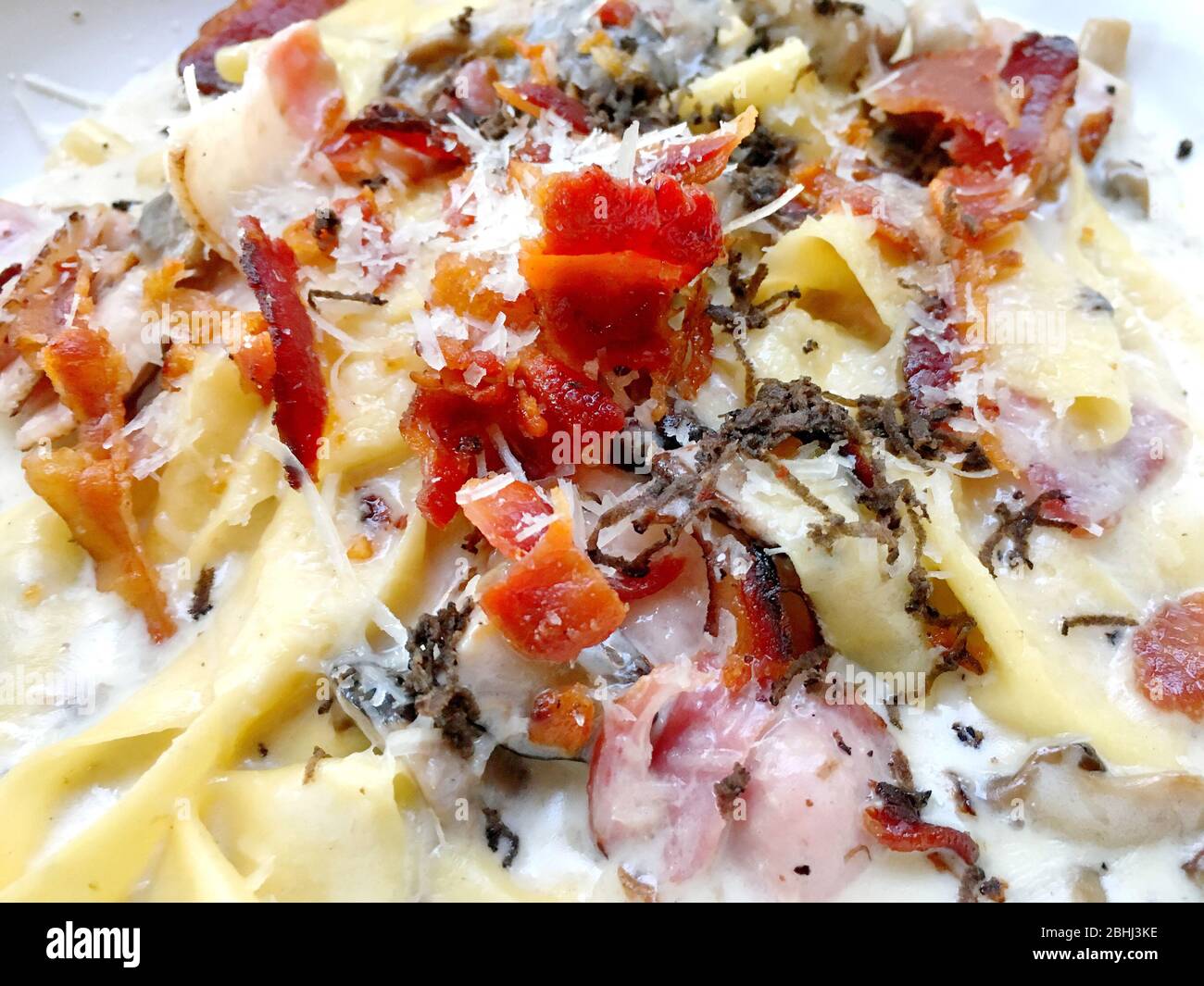 The left over of Pasta Italian food on spoon and white plate Stock ...