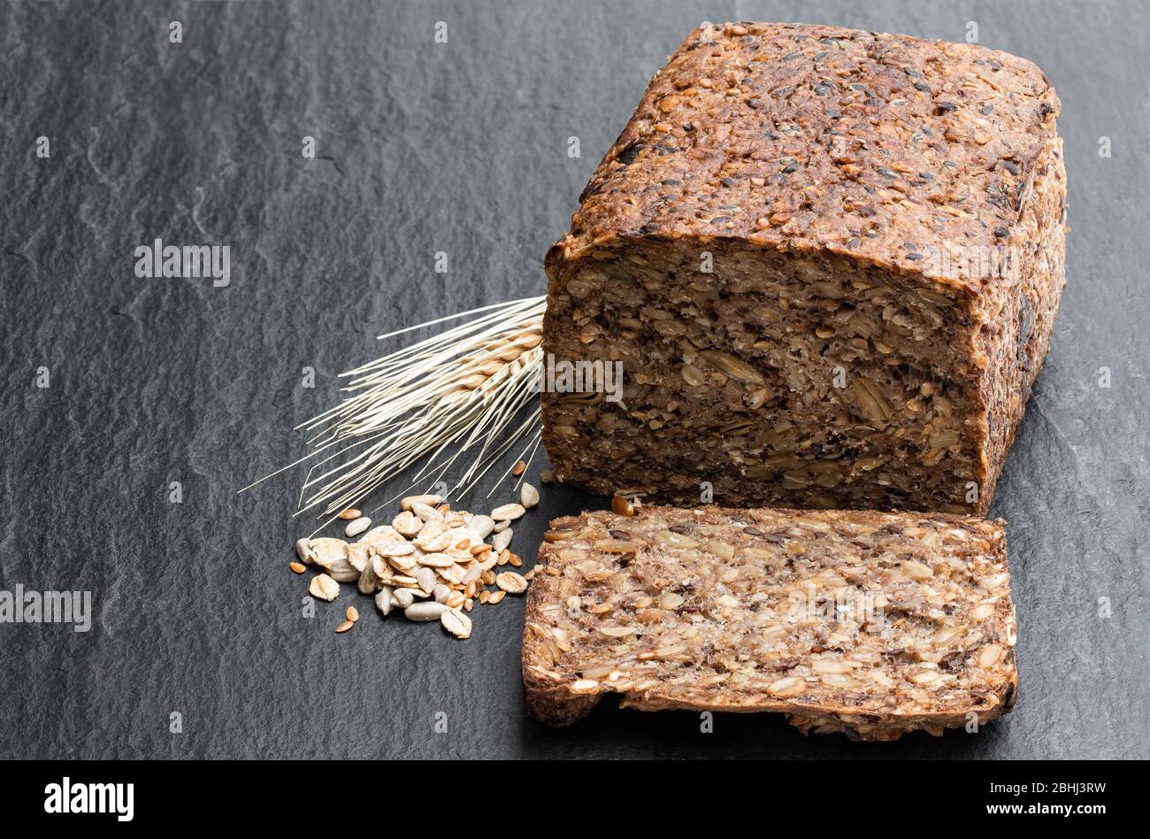 Super seed vegan loaf free from wheat and yeast on black stone ...