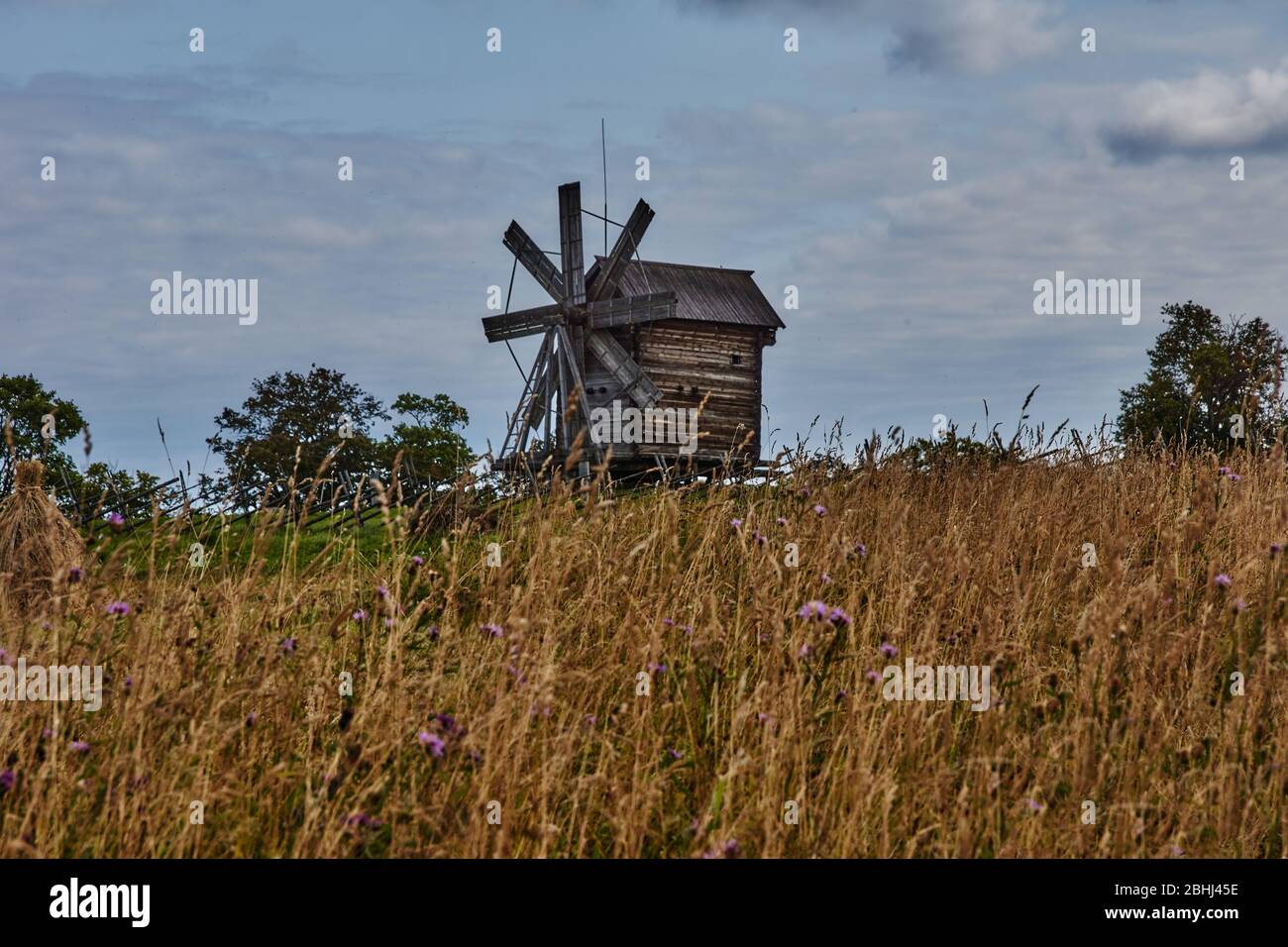 Vintage windmill wooden mill with wind wheel blades. Mill made from ...