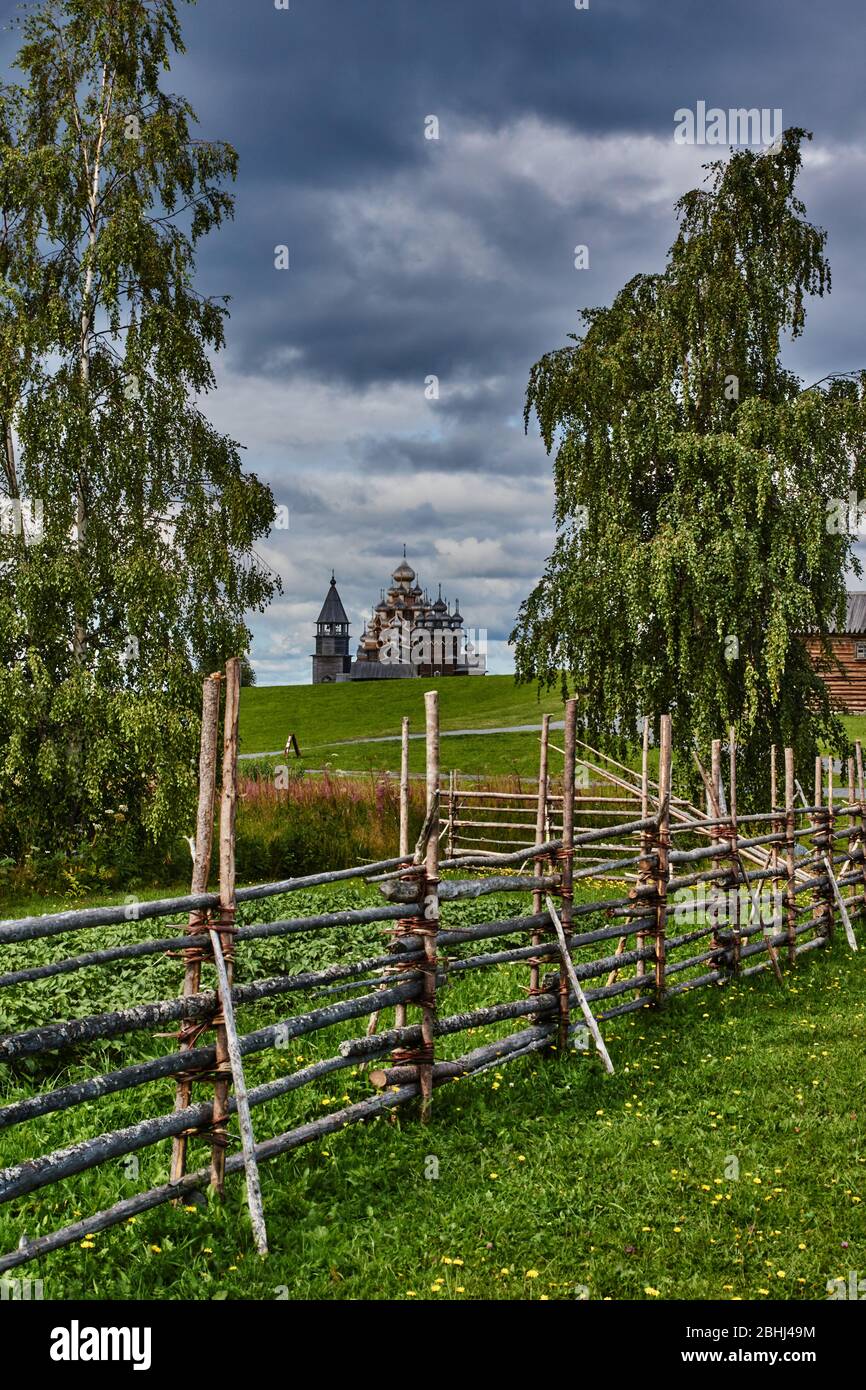 The field is fenced by sloping poles. A typical rural fence around ...
