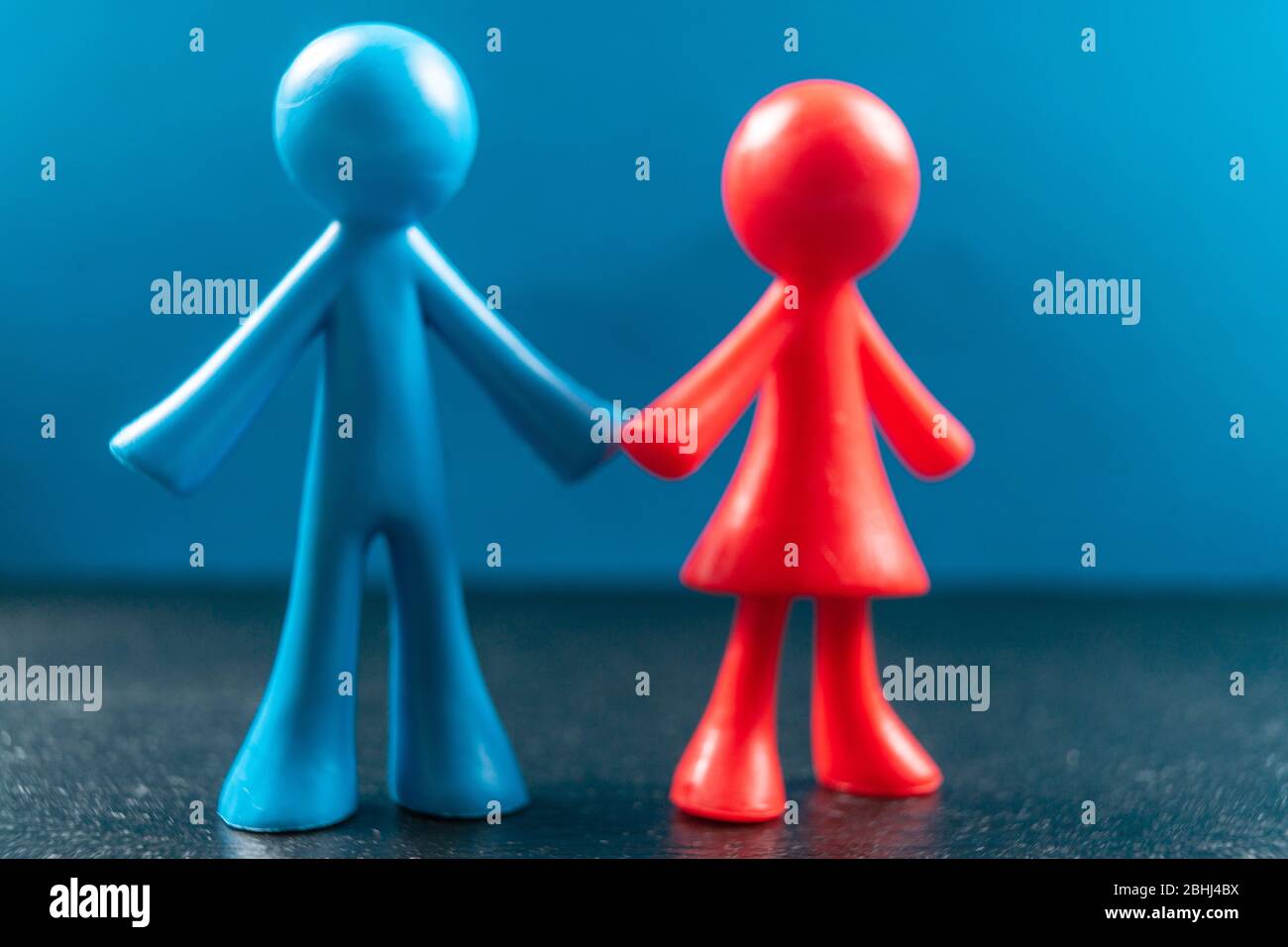Small red and blue plastic toy copleFigurines of an couple Stock Photo ...