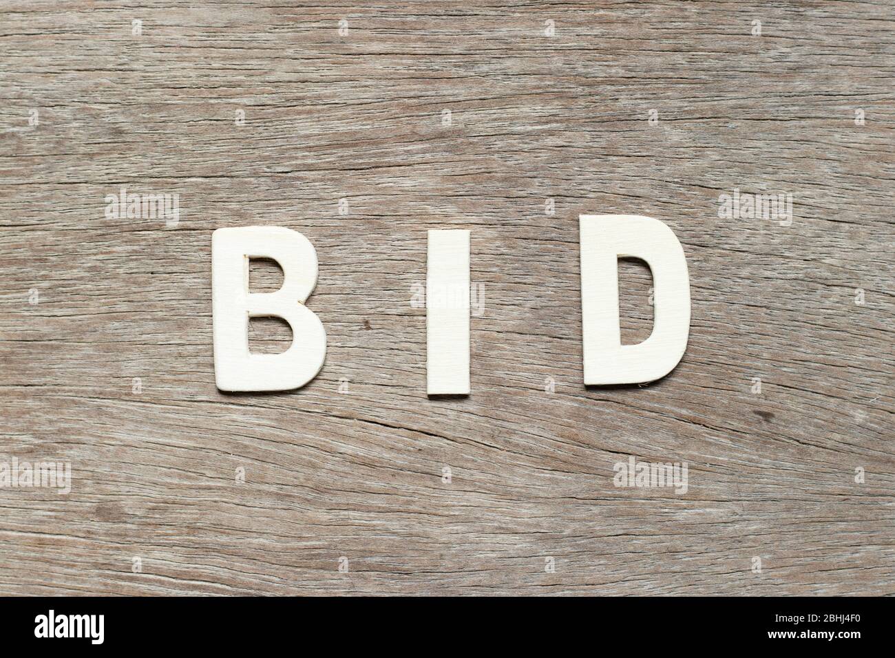 Alphabet letter in word bid on wood background Stock Photo - Alamy
