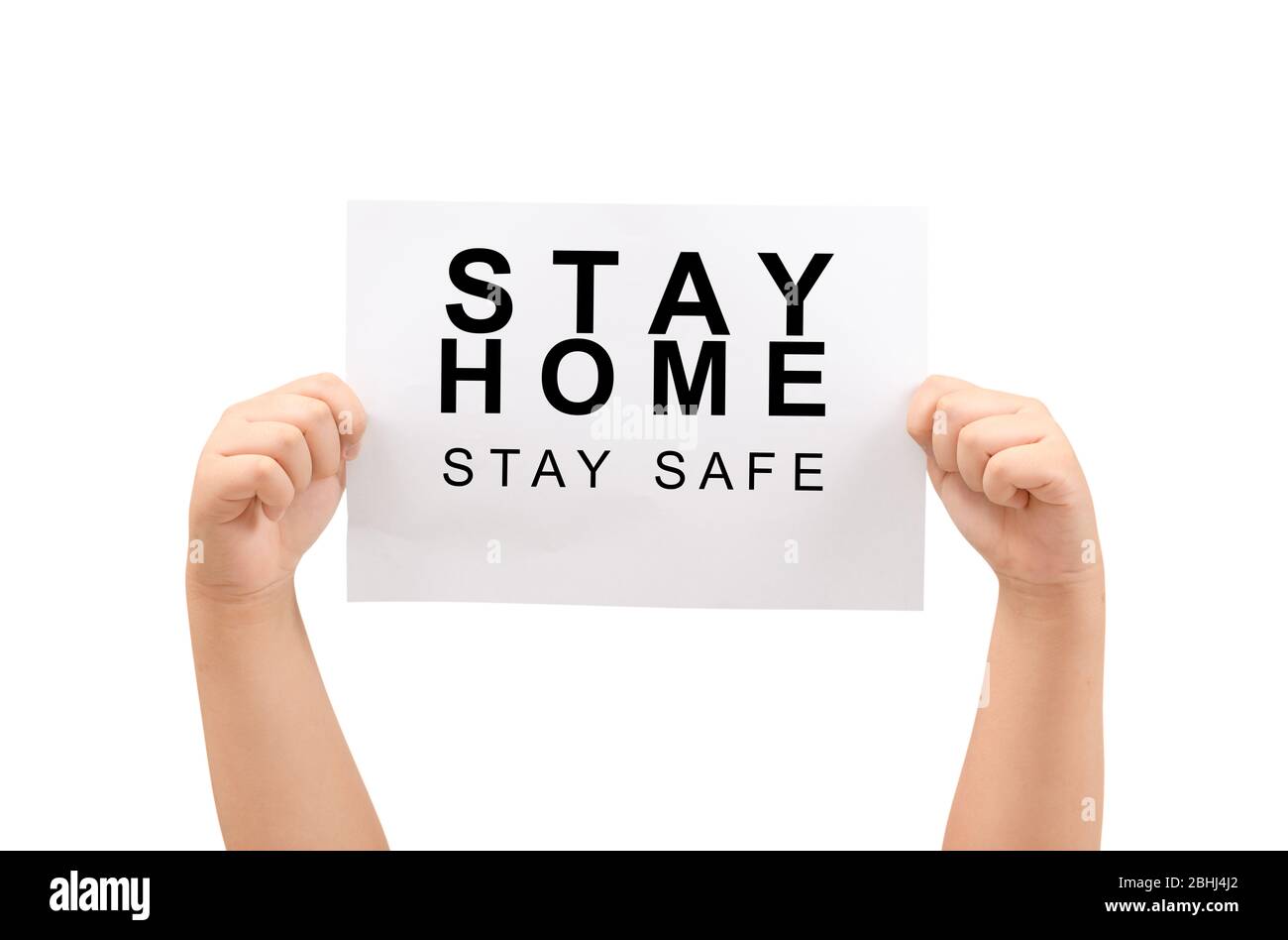Kid's hands holding Stay home, stay safe message on paper isolated on ...