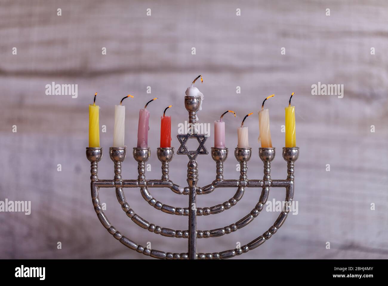 A photograph of an old silver menorah with extinct candles. Hanukkah ...