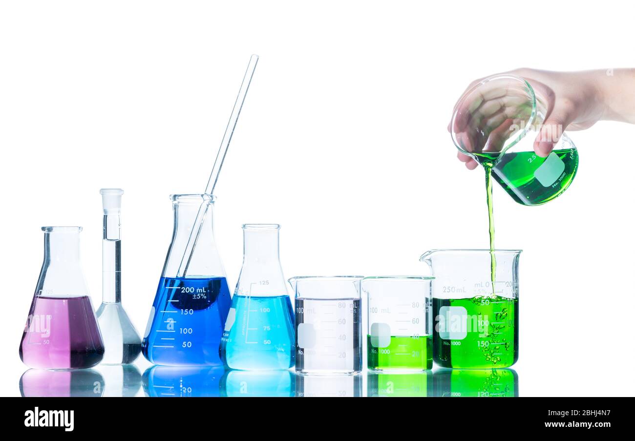 Put green liquid into measuring beaker with laboratory glassware and ...