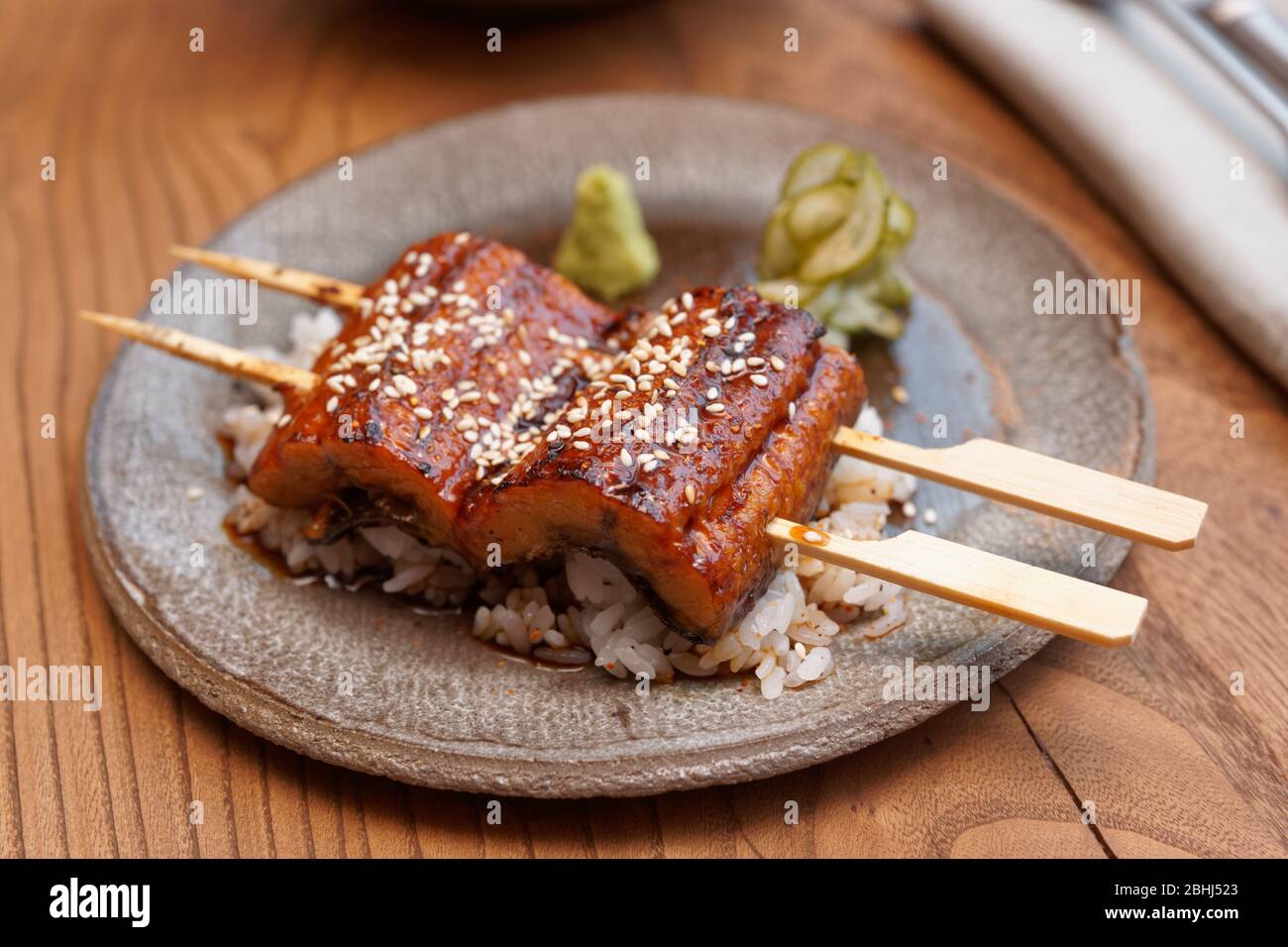 Fried unagi eel with barbecue sauce and rice in clay plate Stock Photo ...