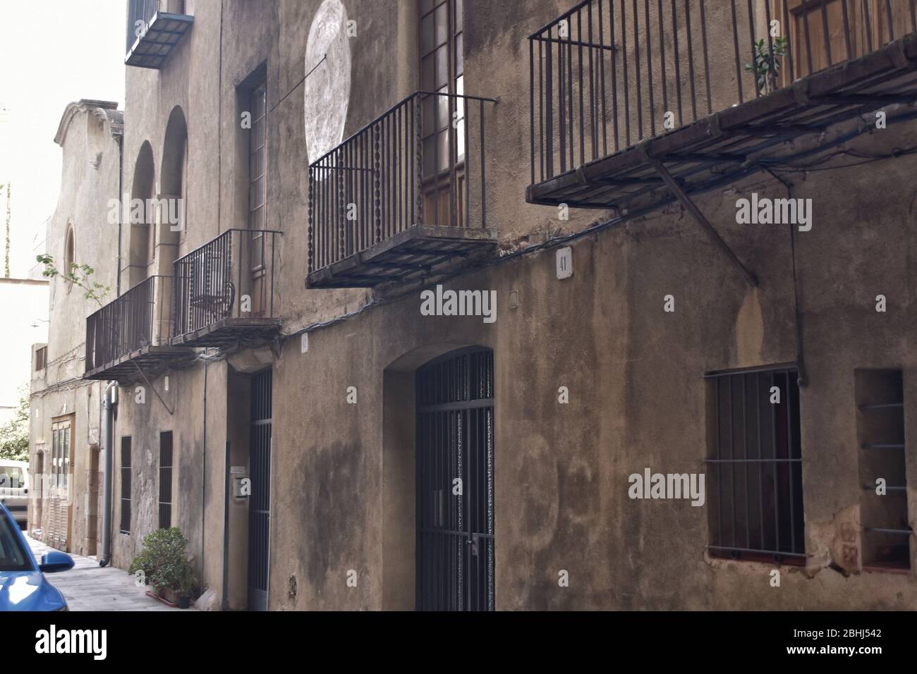 Dingy street with balconies Stock Photo - Alamy