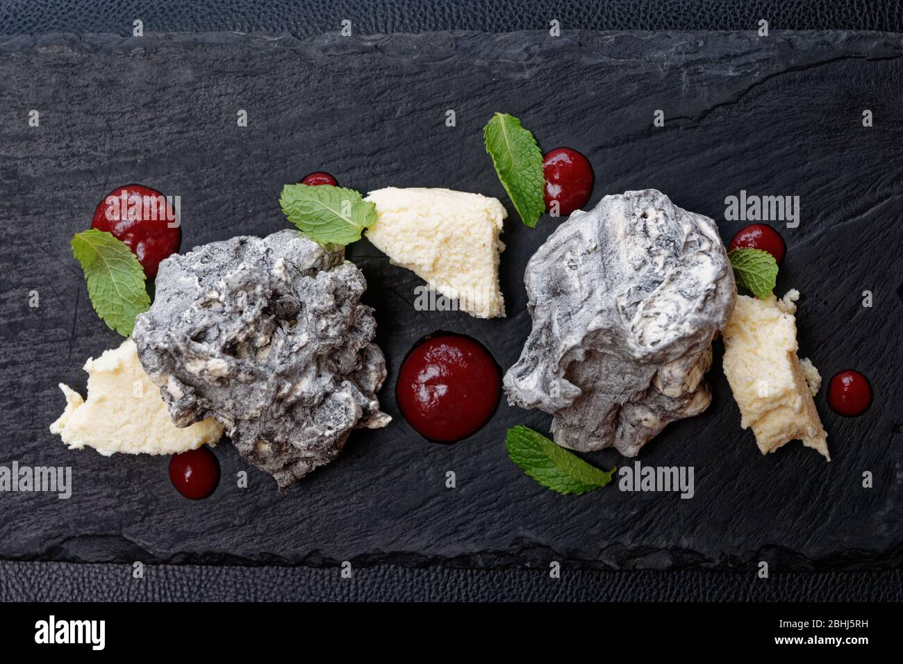 Stone-like dessert on slate plate shot from above Stock Photo - Alamy