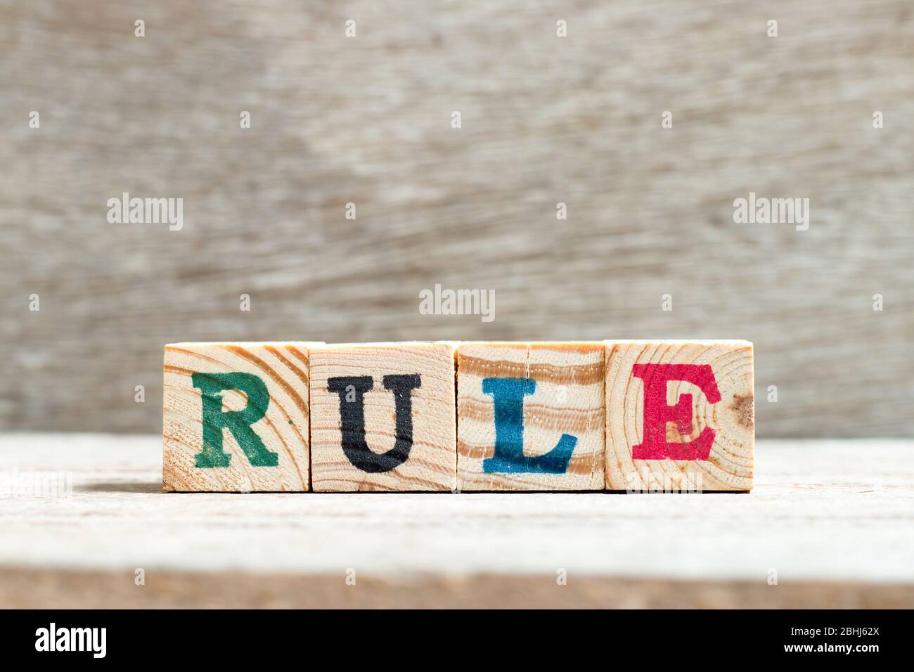 Letter block in word rule on wood background Stock Photo - Alamy
